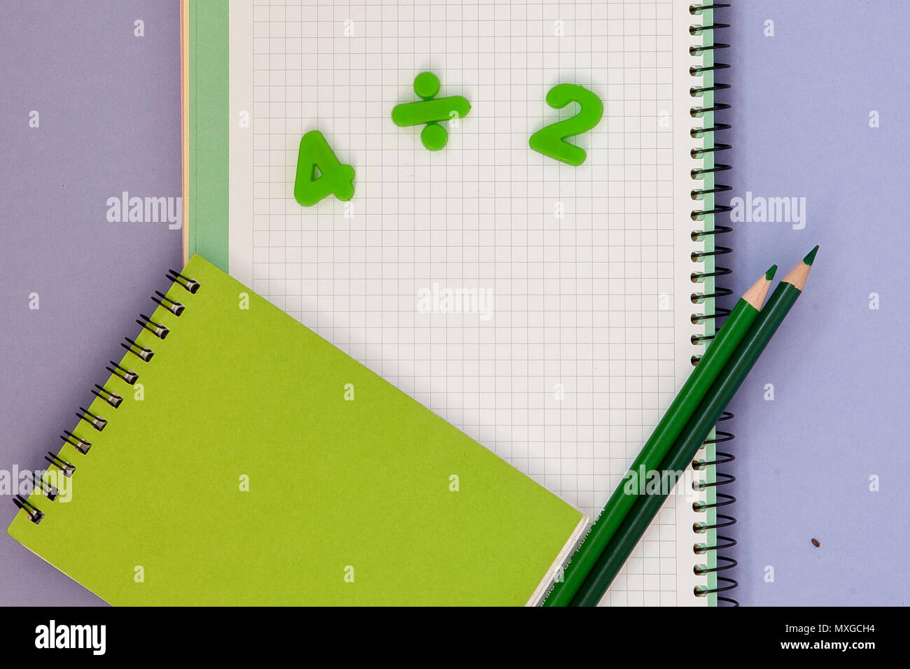 Learning maths. Kid's desk with blank notebook, colorful pencils and ...