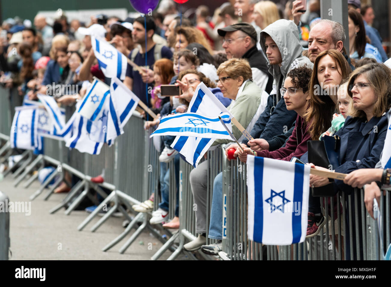 People seen carrying the Israeli flags during the parade. A parade ...