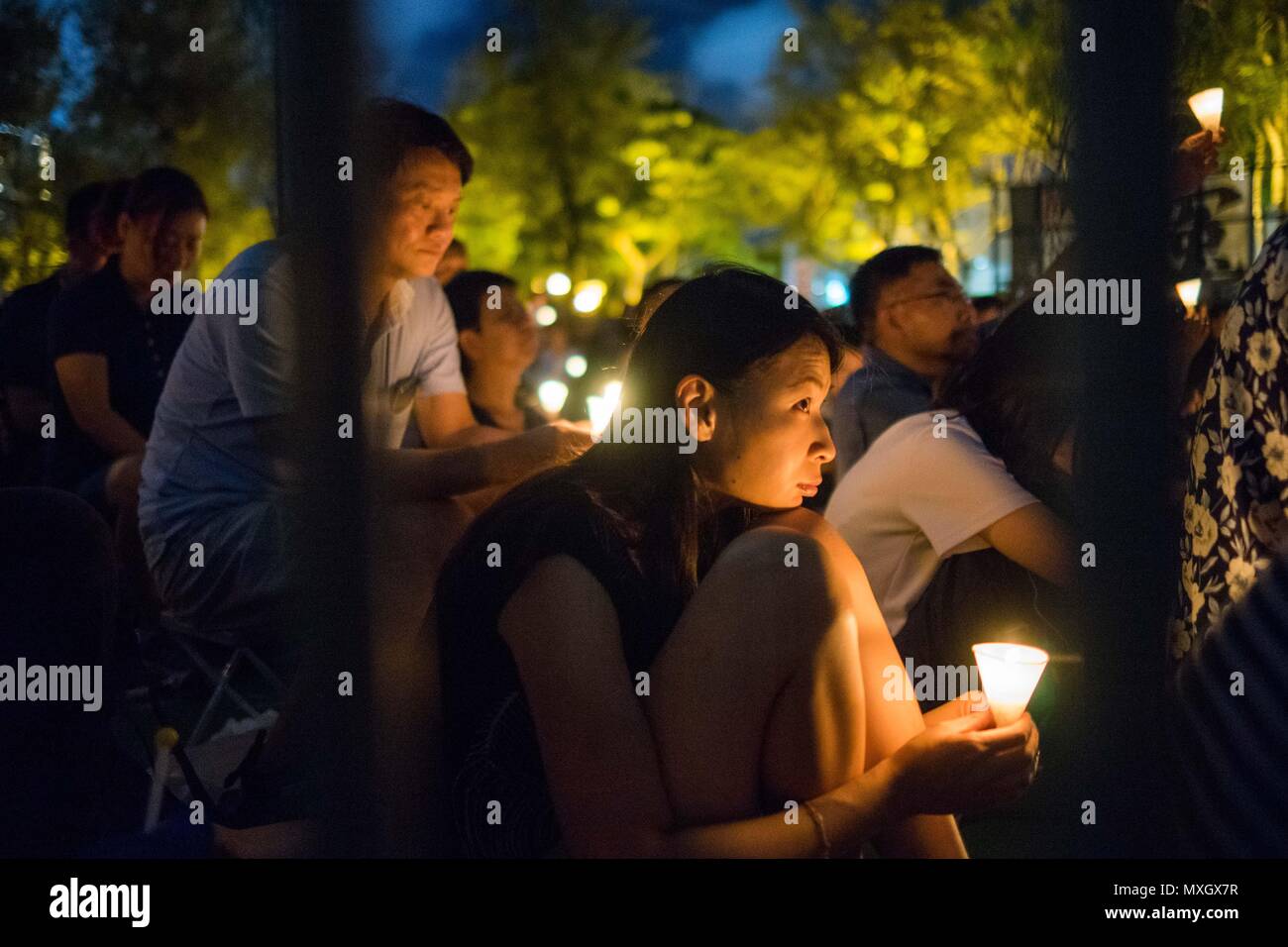Hong Kong, Hong Kong. 4th June, 2018. A young female seen holding a candle during the vigil ...
