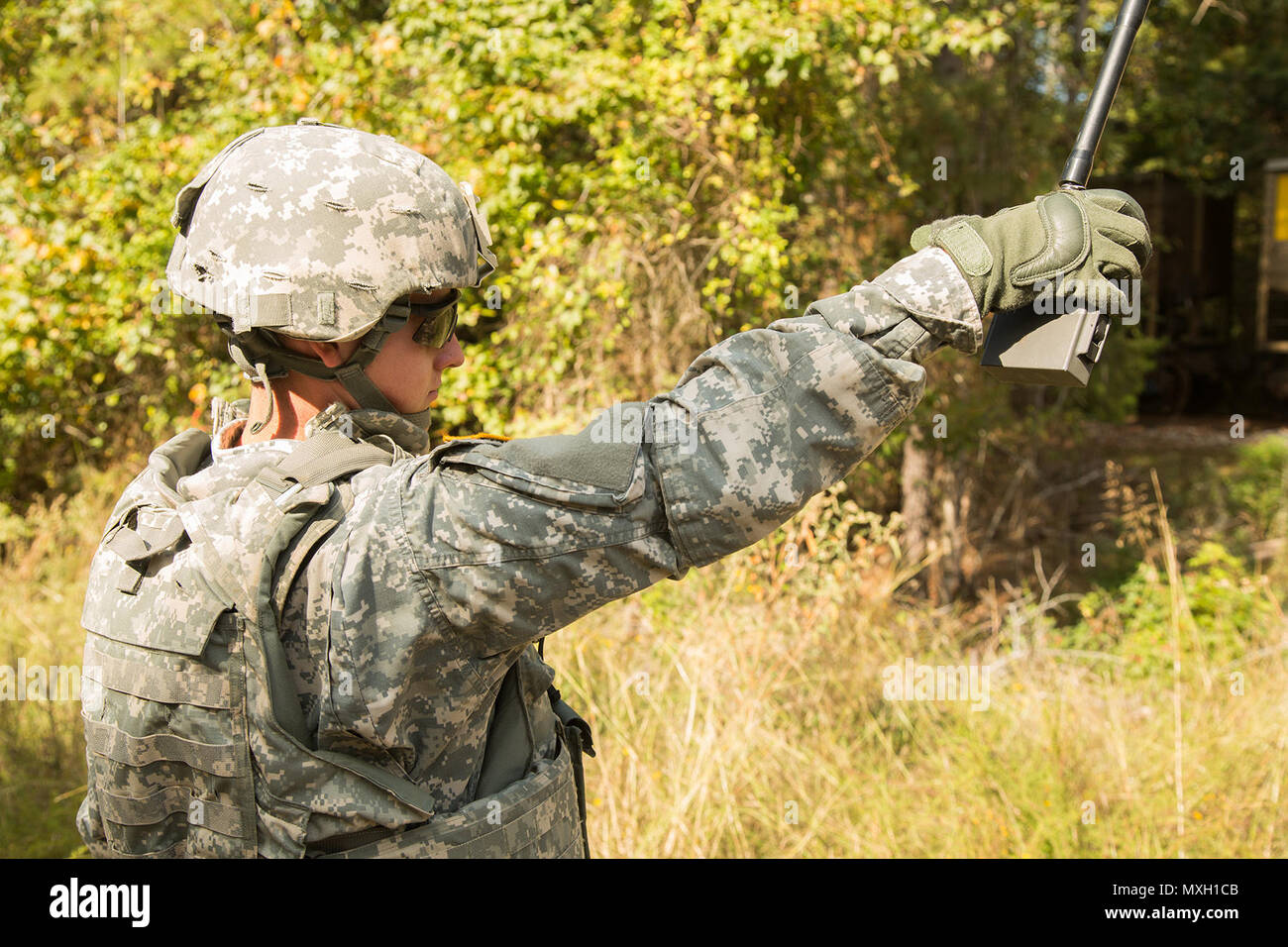 U.S. Army Explosive Ordnance Disposal soldier activates transmitter to ...