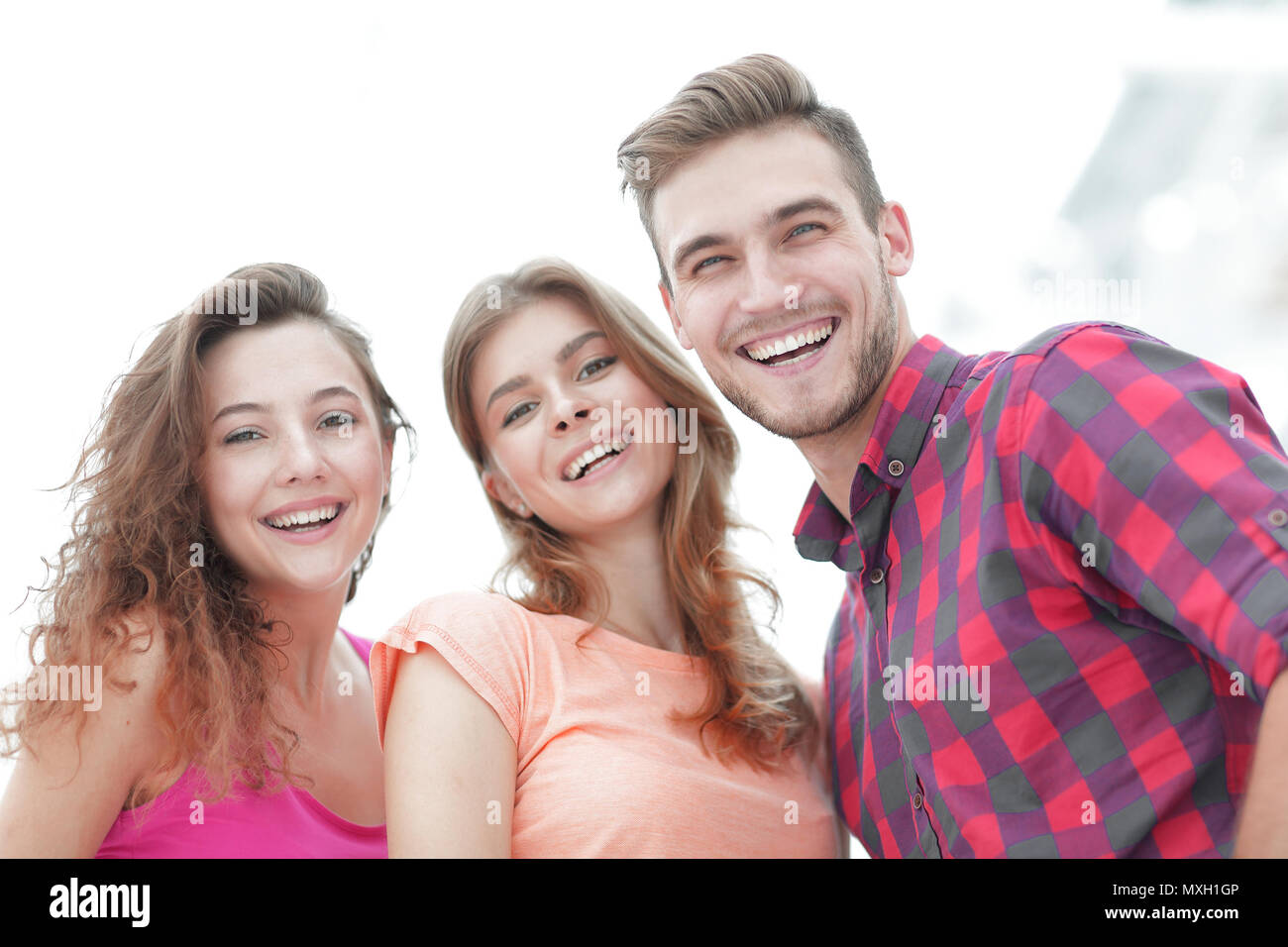 closeup of three young people smiling on white background Stock Photo ...