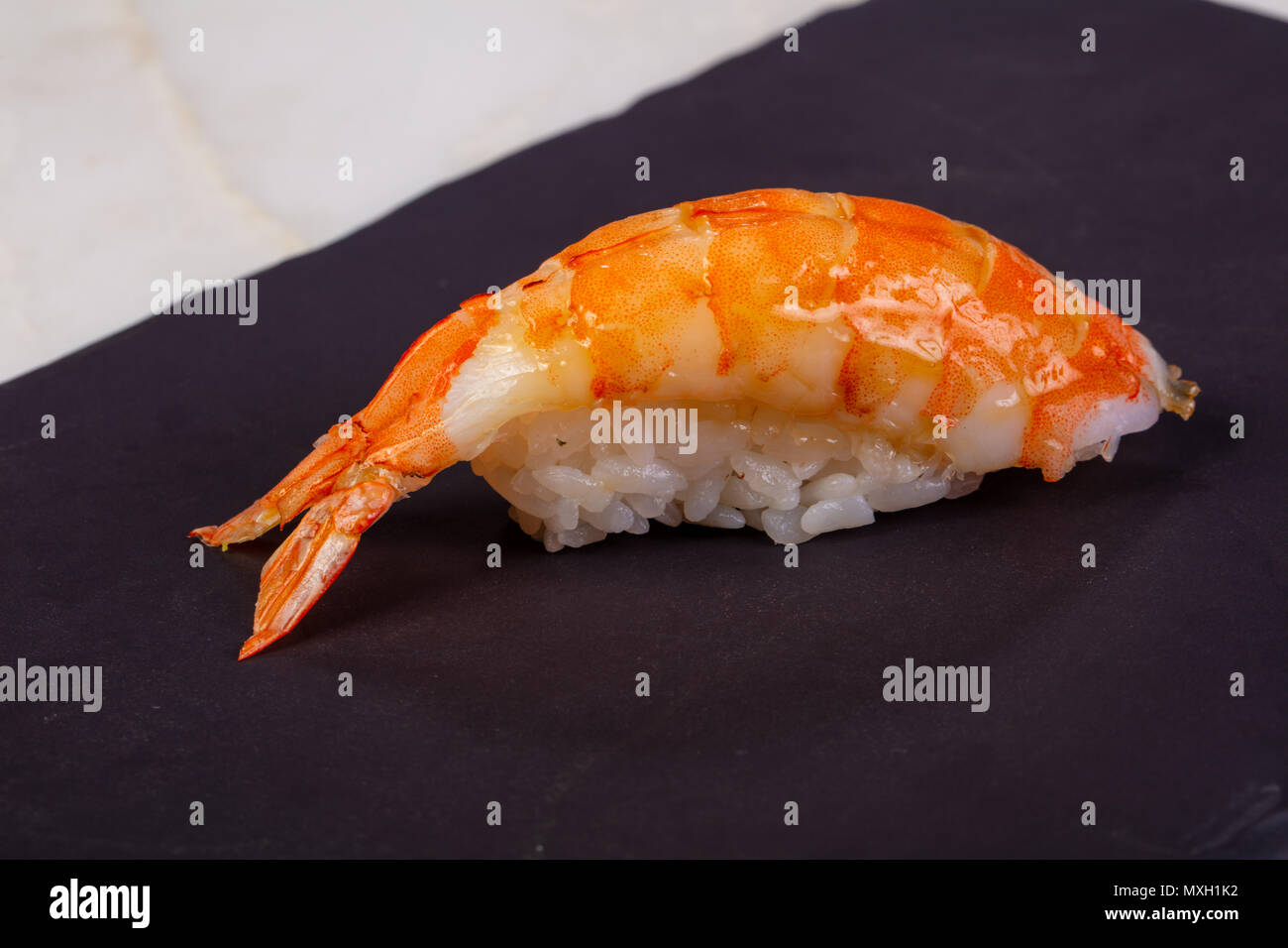 Shrimp nigiri sushi over stone background Stock Photo - Alamy
