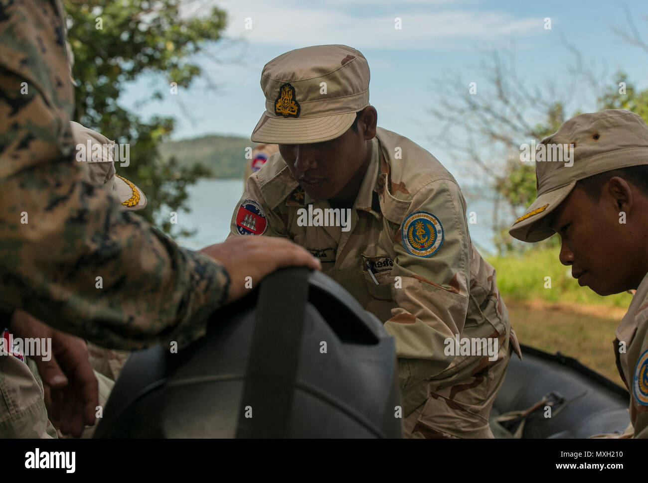 A Royal Cambodian Navy Sailor tests a motor on a Combat Rubber ...
