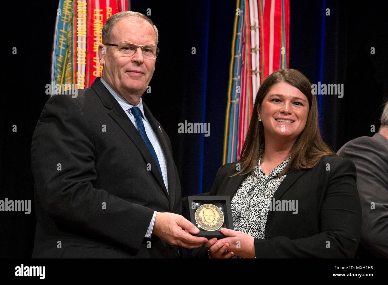 Deputy Defense Secretary Bob Work, left, presents the Excellence in ...