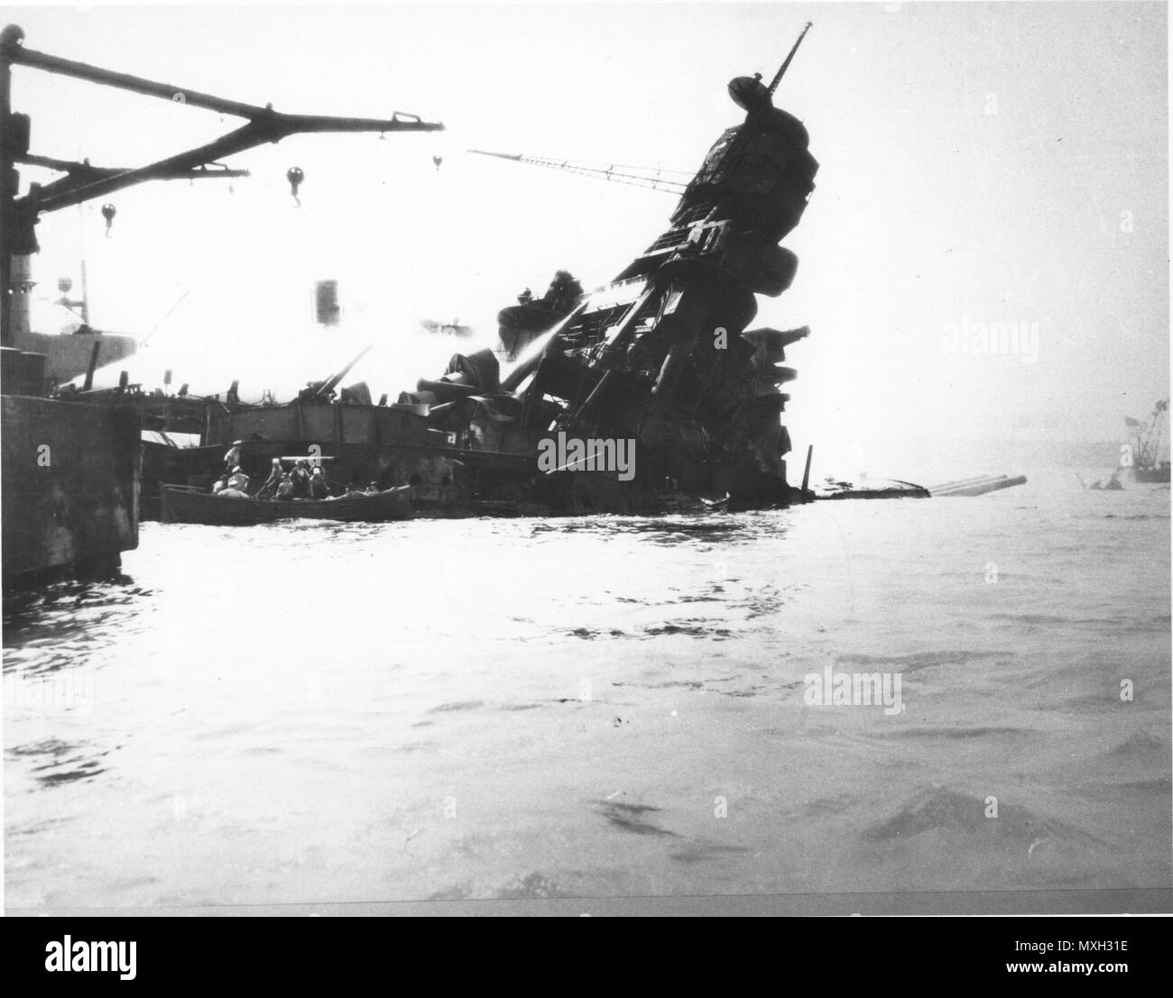 Original caption: The USS Arizona (BB39) burning after the Japanese ...