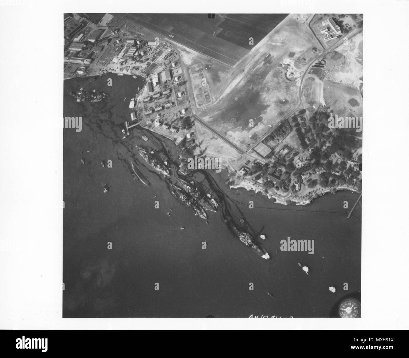 Original caption: Ships at Pearl Harbor, T.H. following the Japanese ...