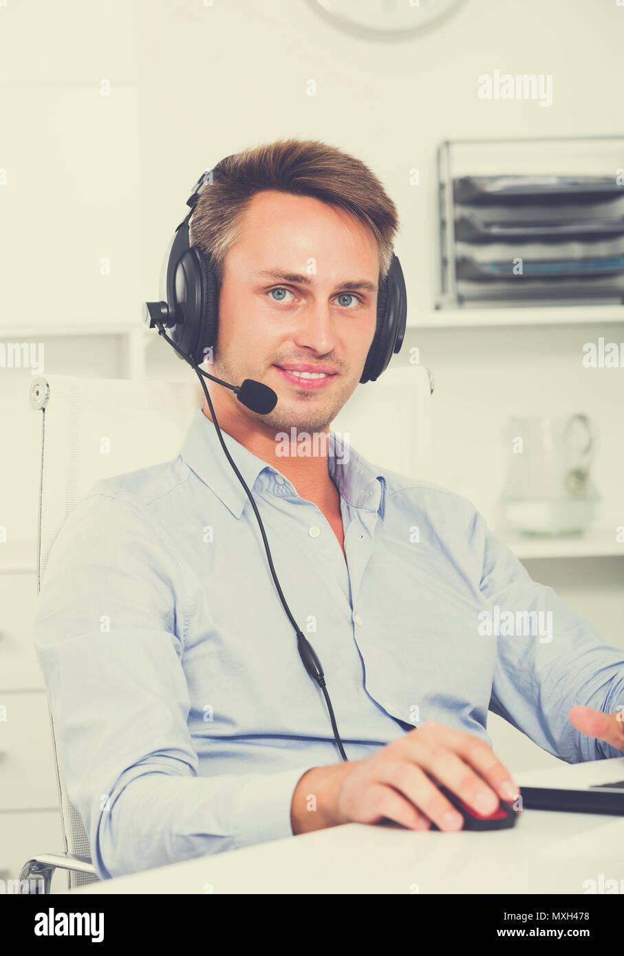 Happy male operator with headset on answering at call center Stock ...