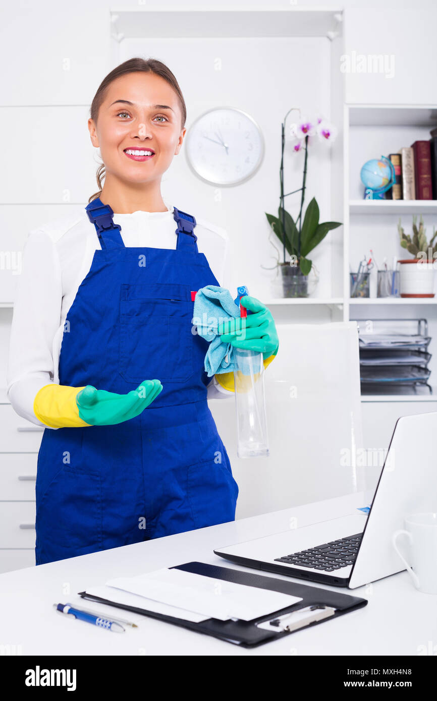 Happy woman wearing uniform cleaning at company office Stock Photo - Alamy