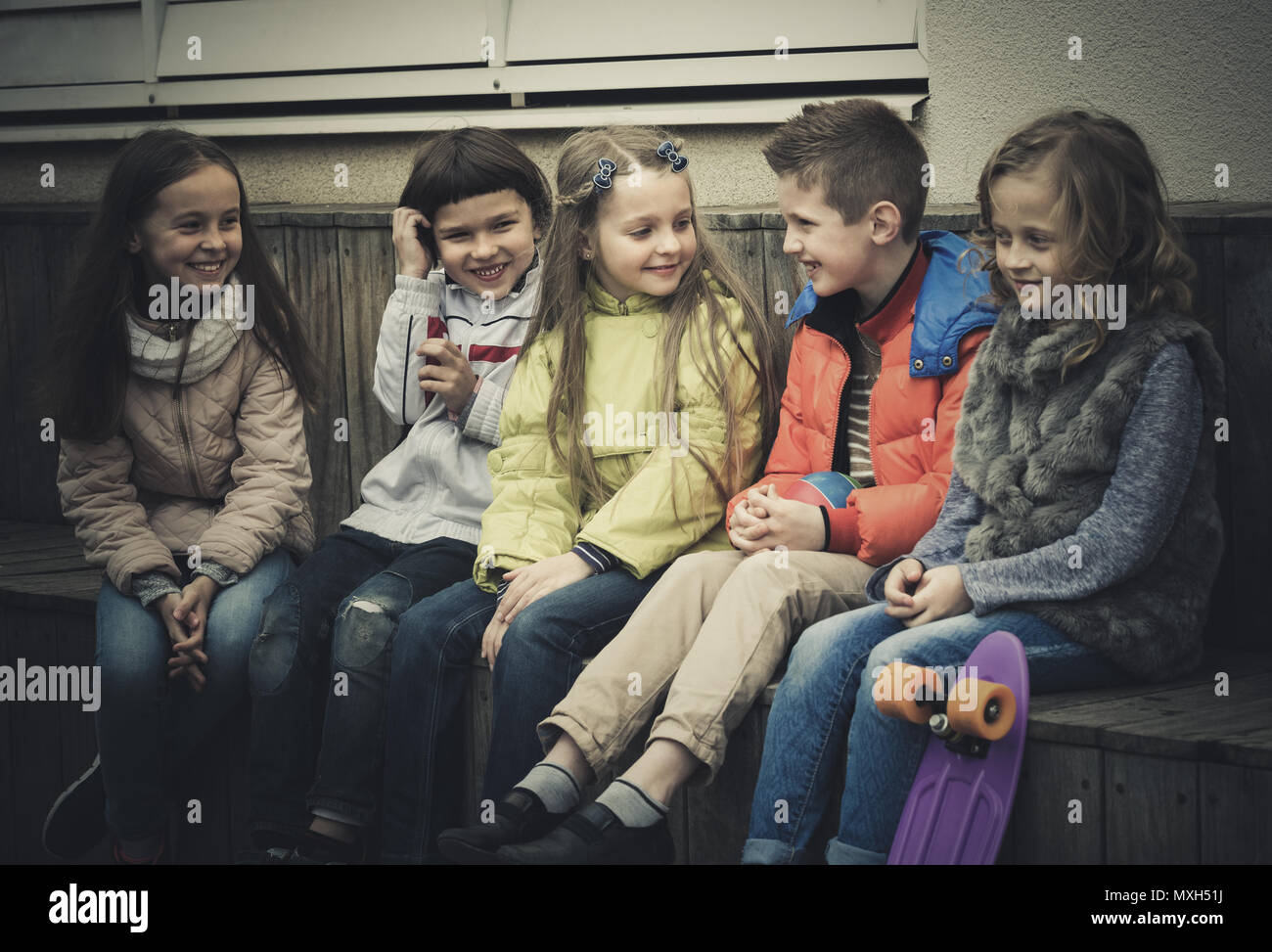 Positive kids chatting and having fun outdoor in city street Stock ...