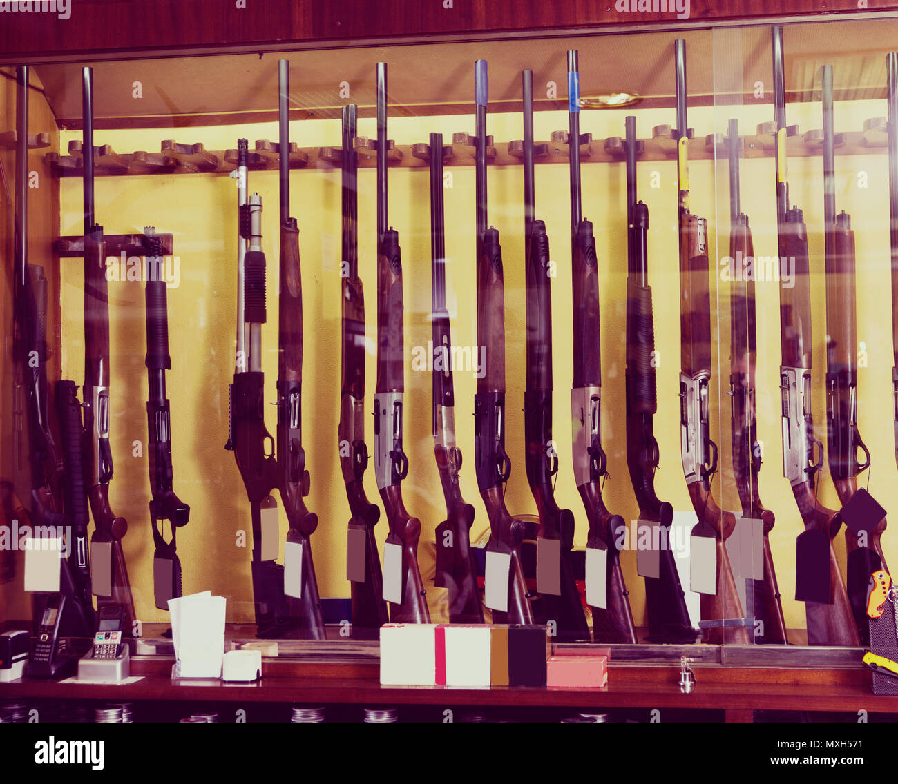 Gun store interior with different rifles on showcase Stock Photo - Alamy