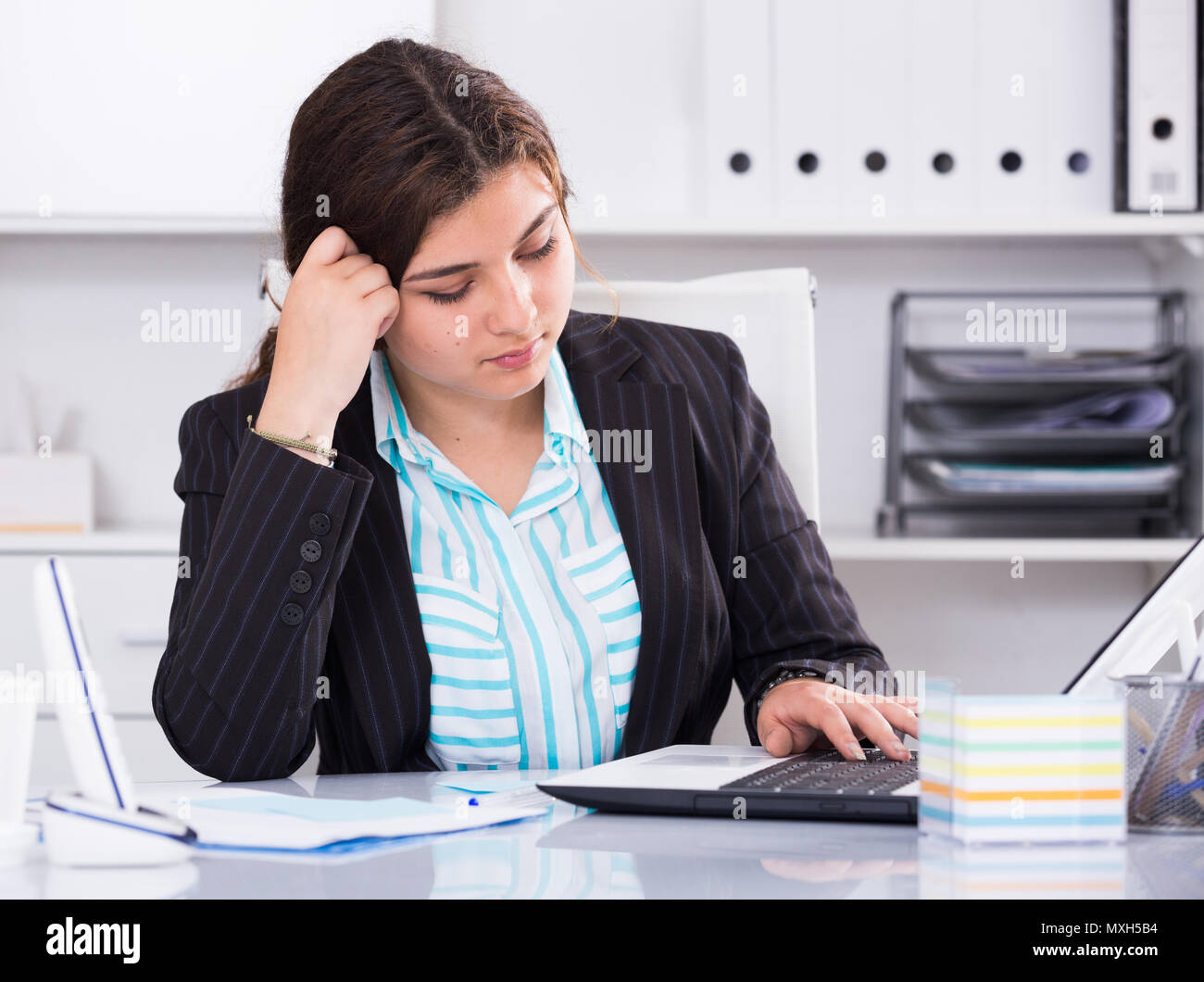 Female is having complicated issue with project in office Stock Photo ...
