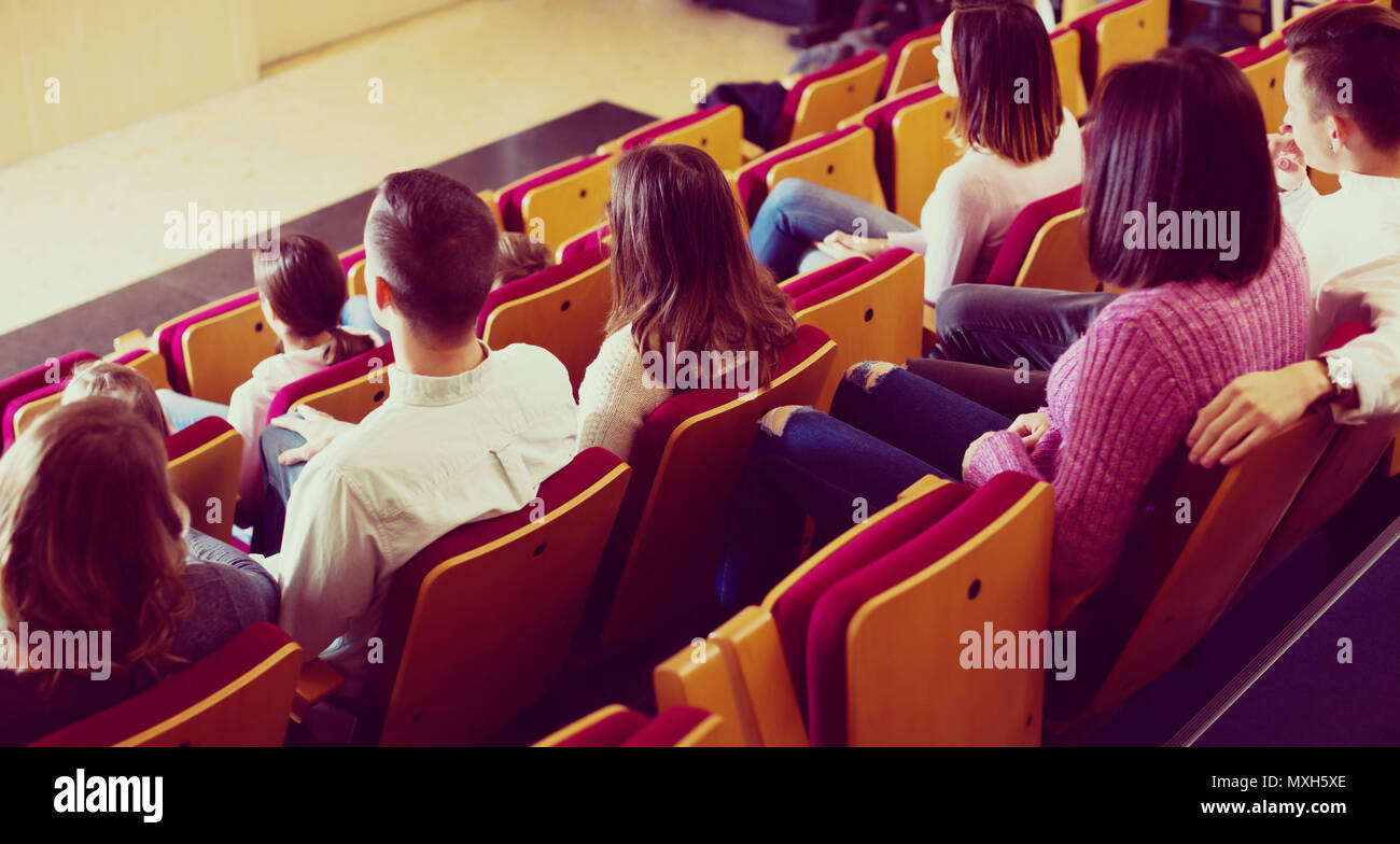 Glad audience expecting movie to begin in cinema Stock Photo - Alamy