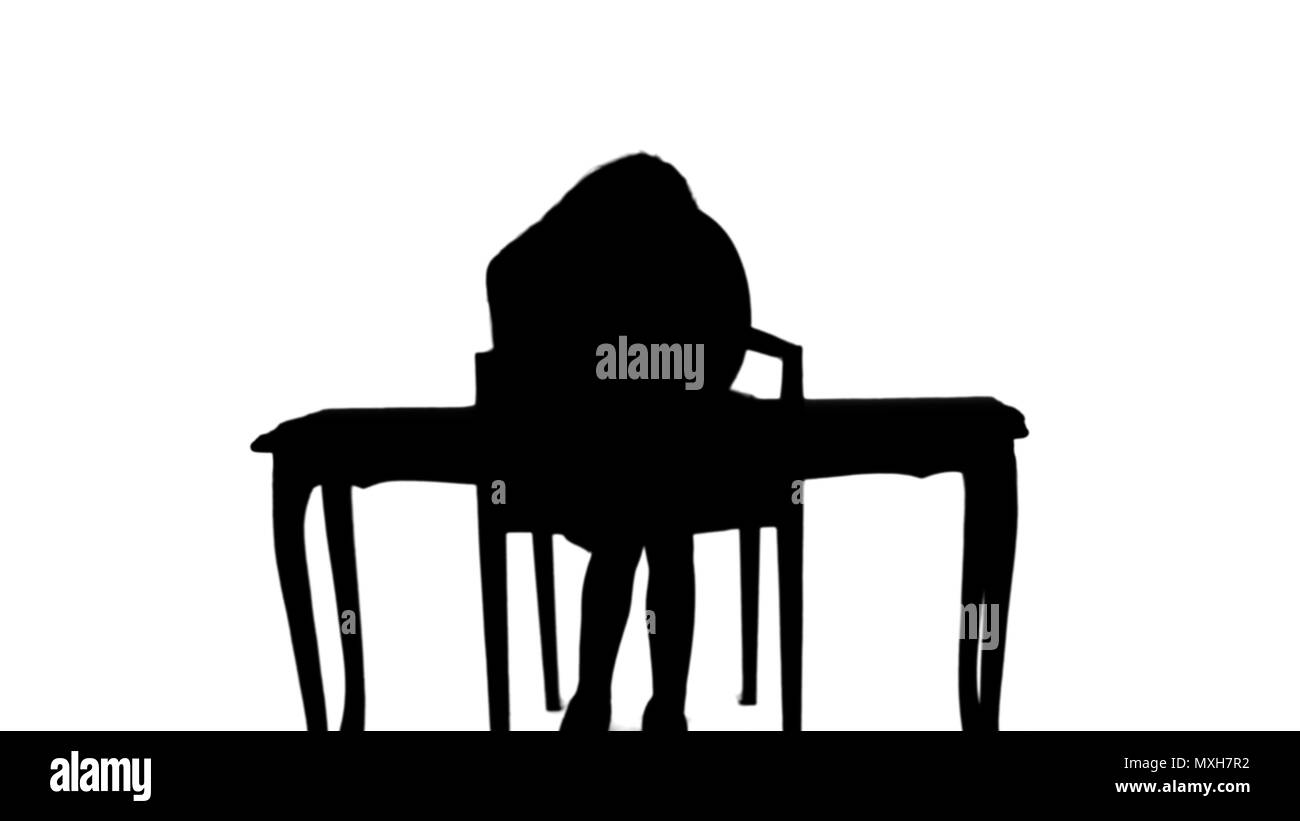 Silhouette Cute little girl doing homework, writing down track matte ...