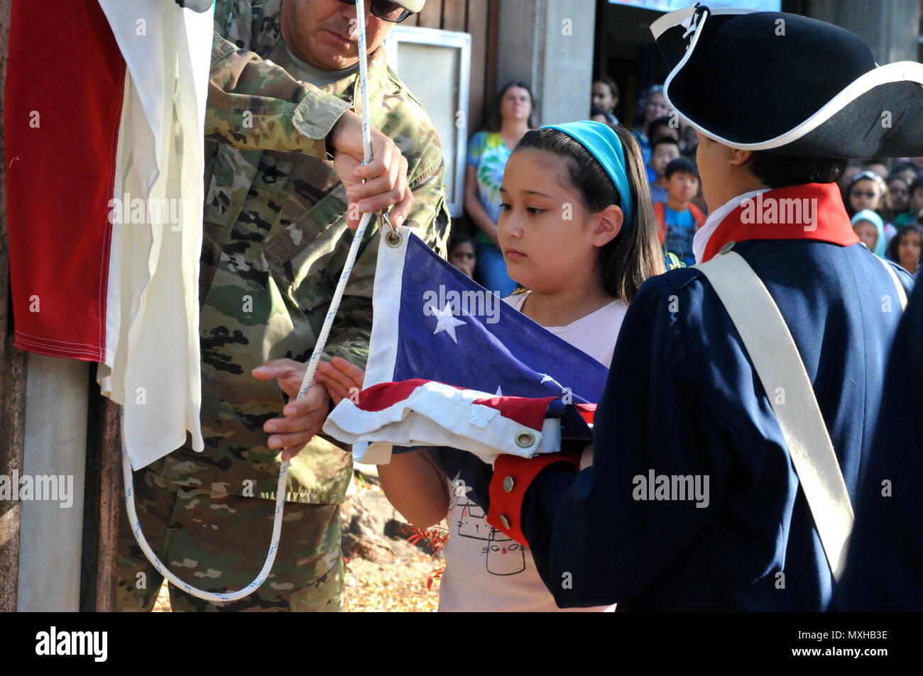 Assisted by Sgt. Arleen Banioza (right), color guard noncommissioned ...