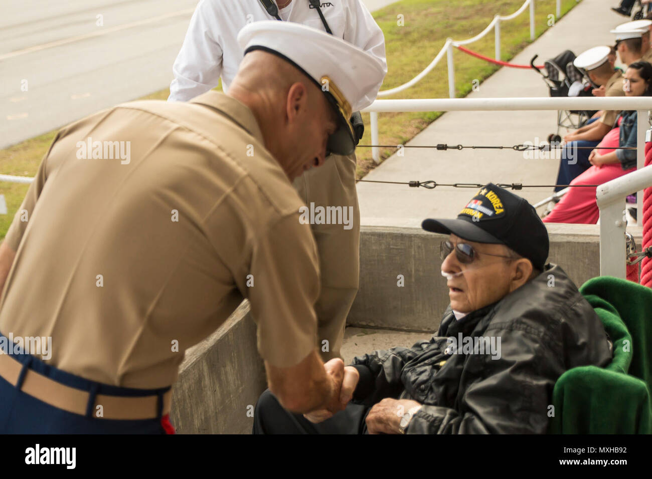 Larry L. Cooper Jr., right, shakes hands with Col. Matthew St. Clair ...