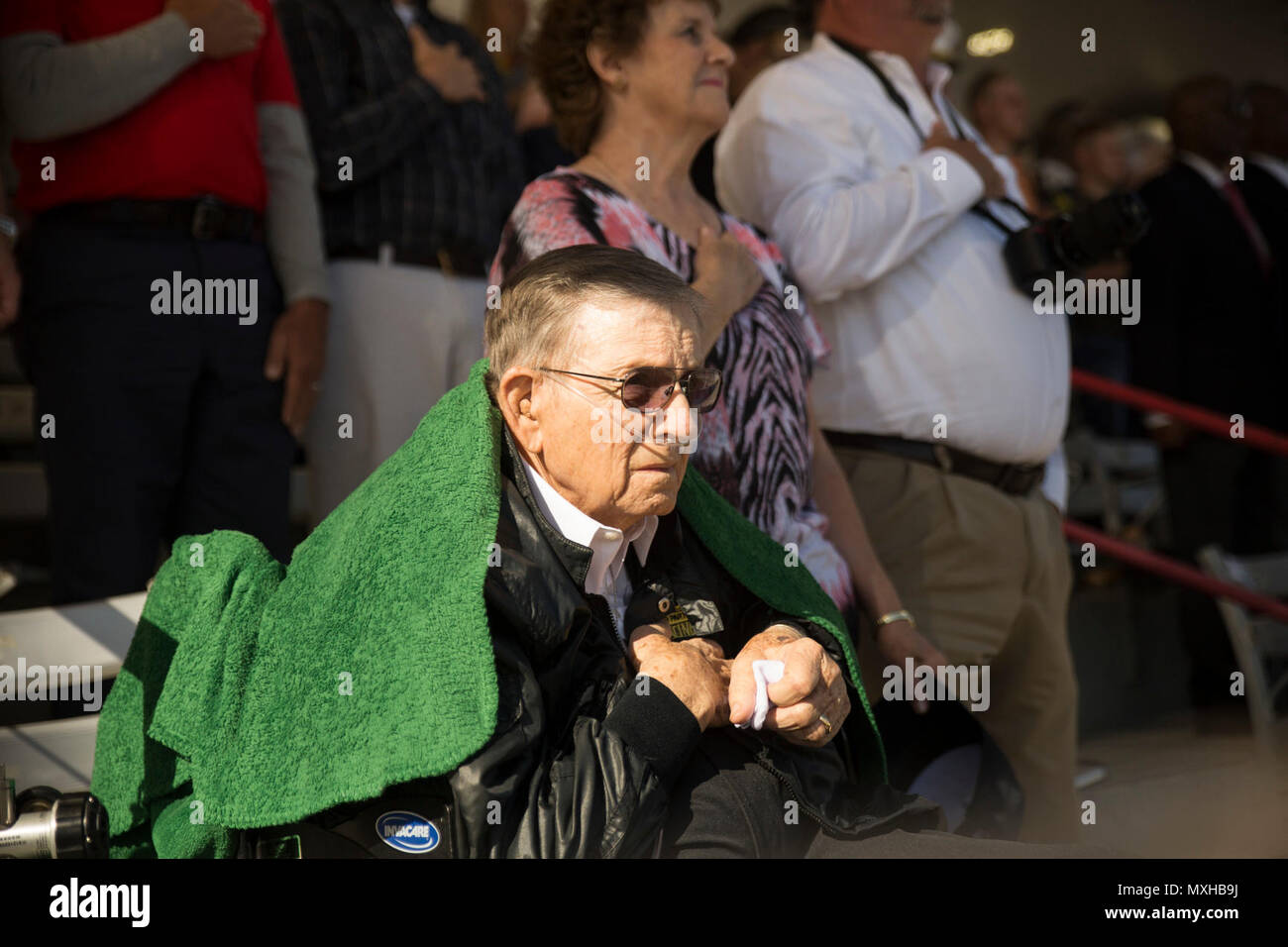 Larry L. Cooper Jr. places his hand over his heart during the national ...