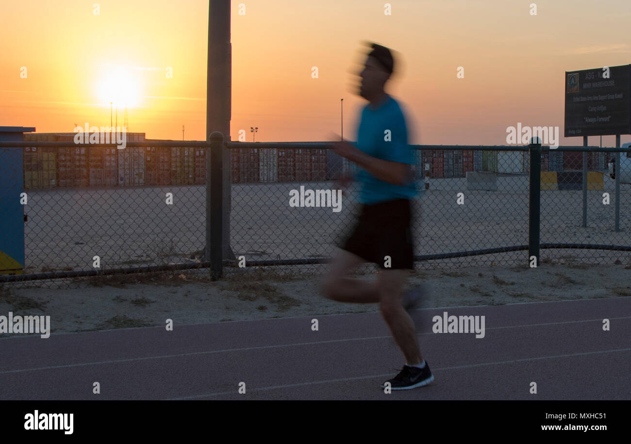 A service member runs the final stretch of the MWR Veteran's Day 5k run ...