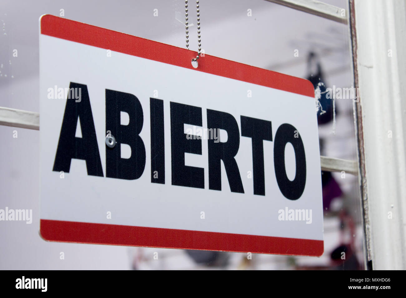 An spanish open sign hanging in a store. Abierto meaning open Stock ...