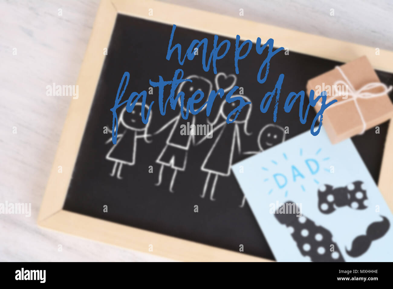 Children drawing on a blackboard with greeting card and gift box on ...