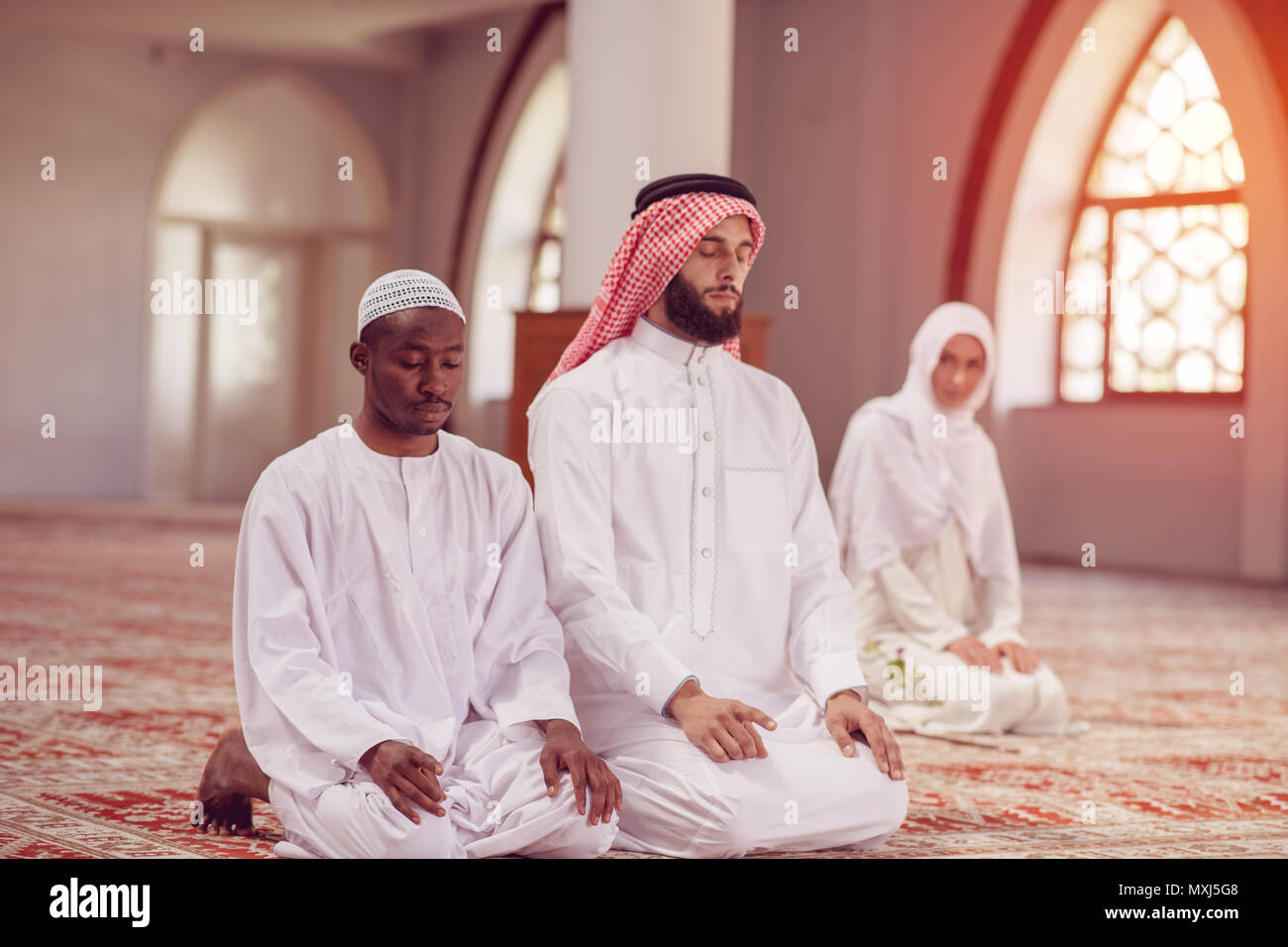 Two religious young people praying inside the mosque. islamic Stock ...