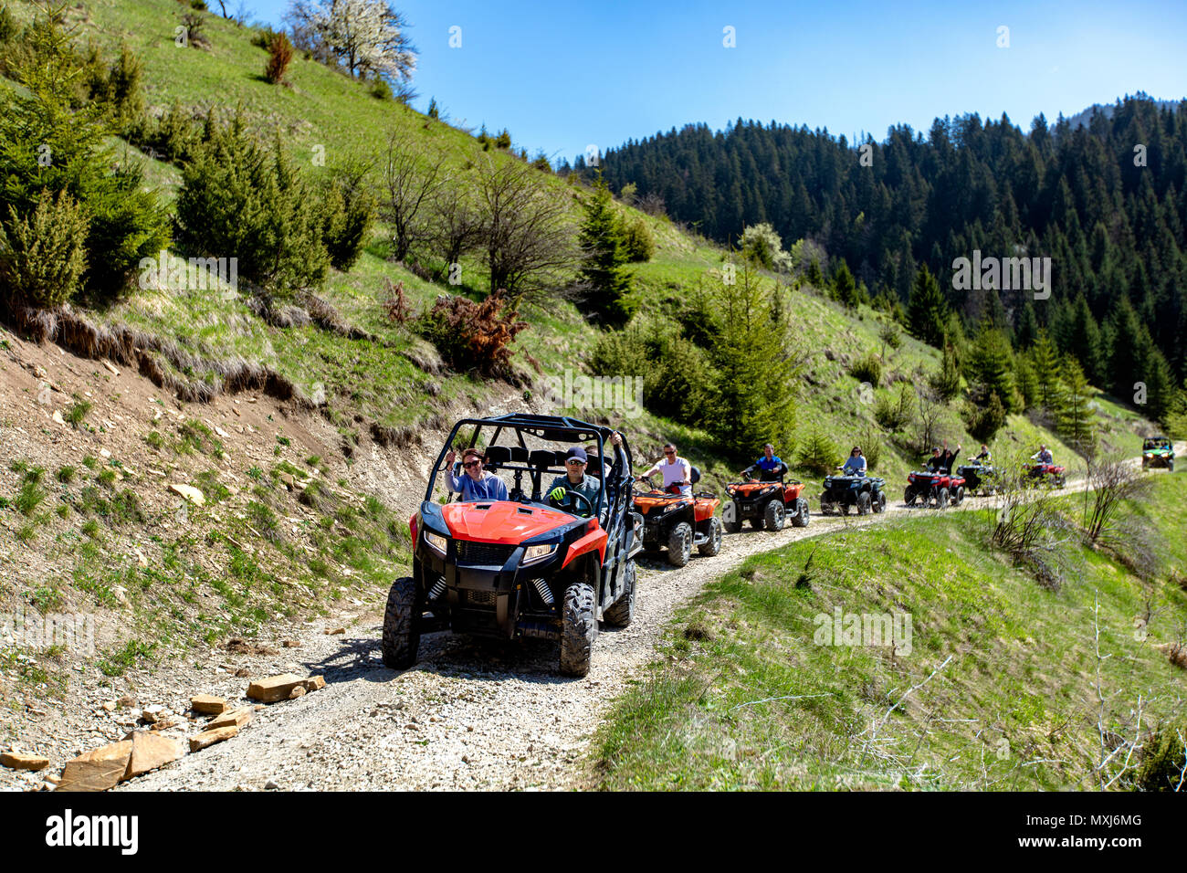 A tour group travels on ATVs and UTVs on the mountains Stock Photo - Alamy