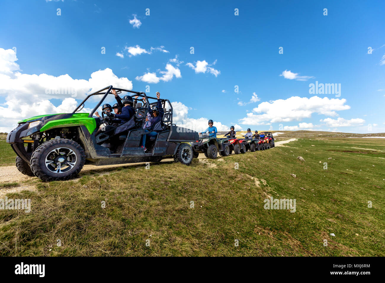Friends driving off-road with quad bike or ATV and UTV vehicles Stock ...