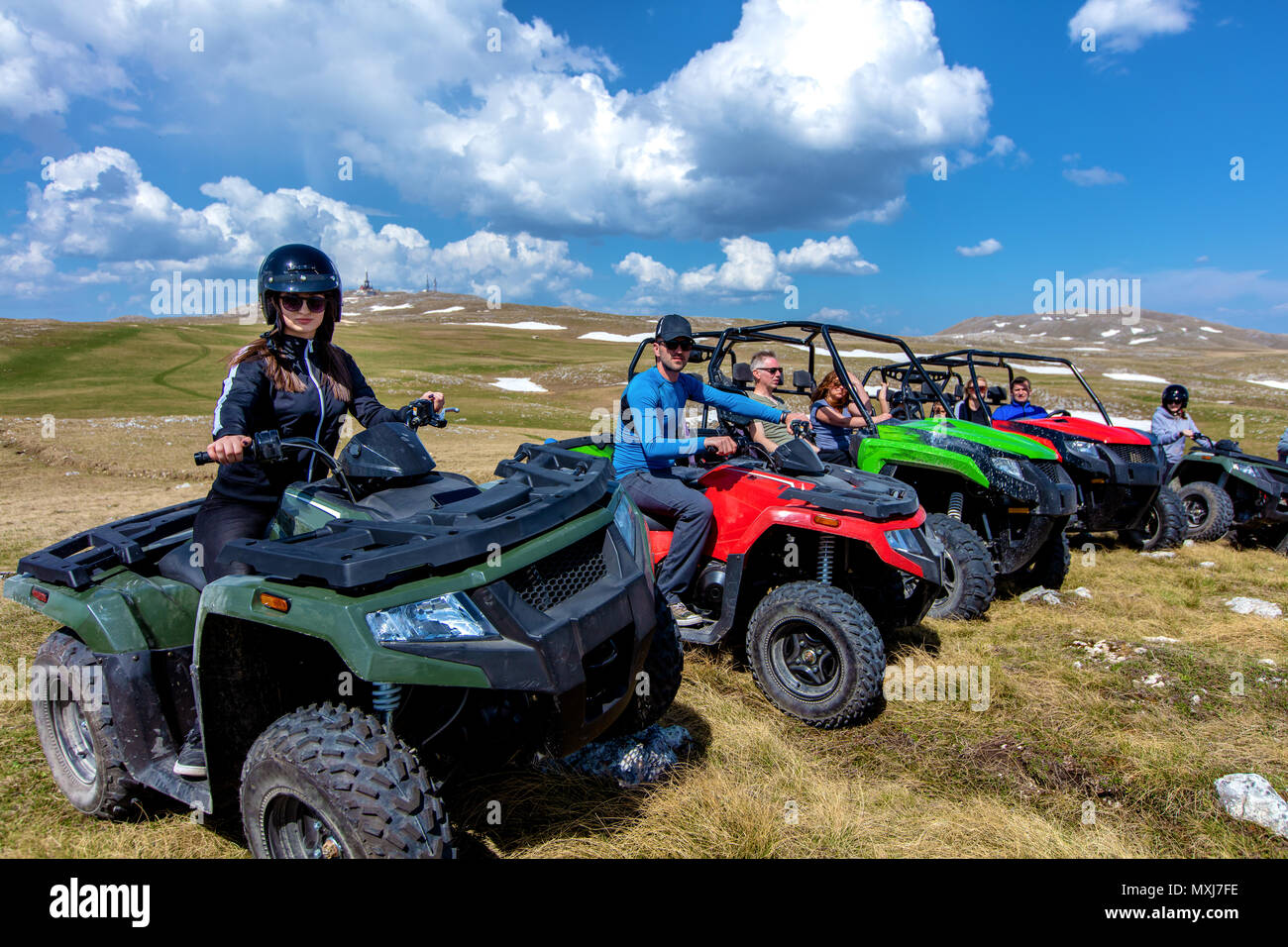 Friends driving off-road with quad bike or ATV and UTV vehicles Stock ...