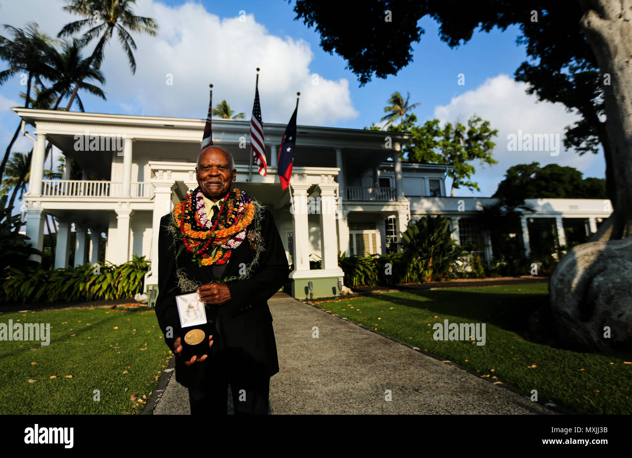 Dr. Ernest James Harris, Jr. stood holding his Congressional Gold Medal ...