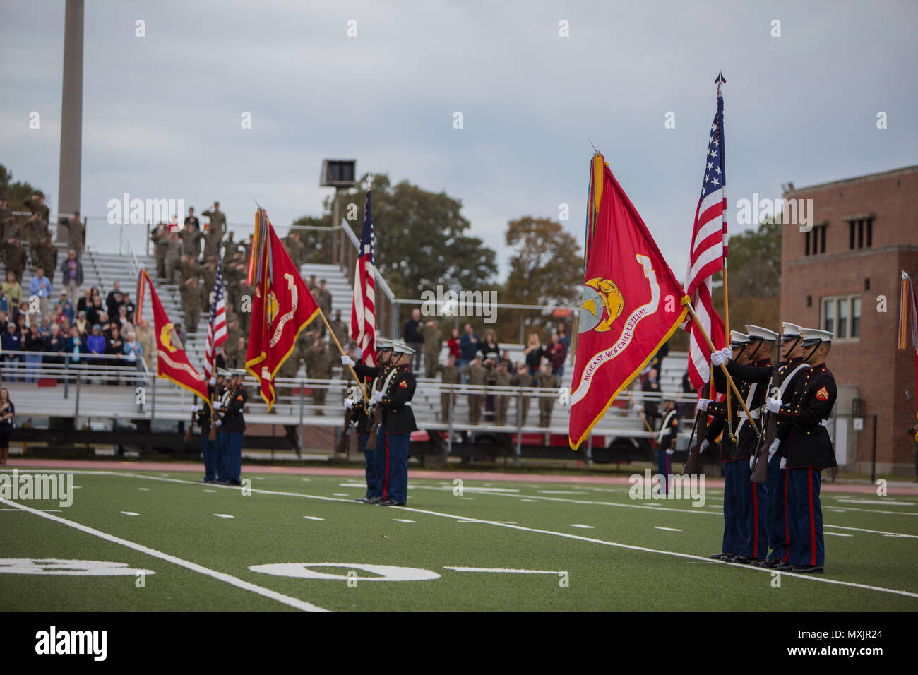 U.S. Marines with color guards from various units present arms for the ...