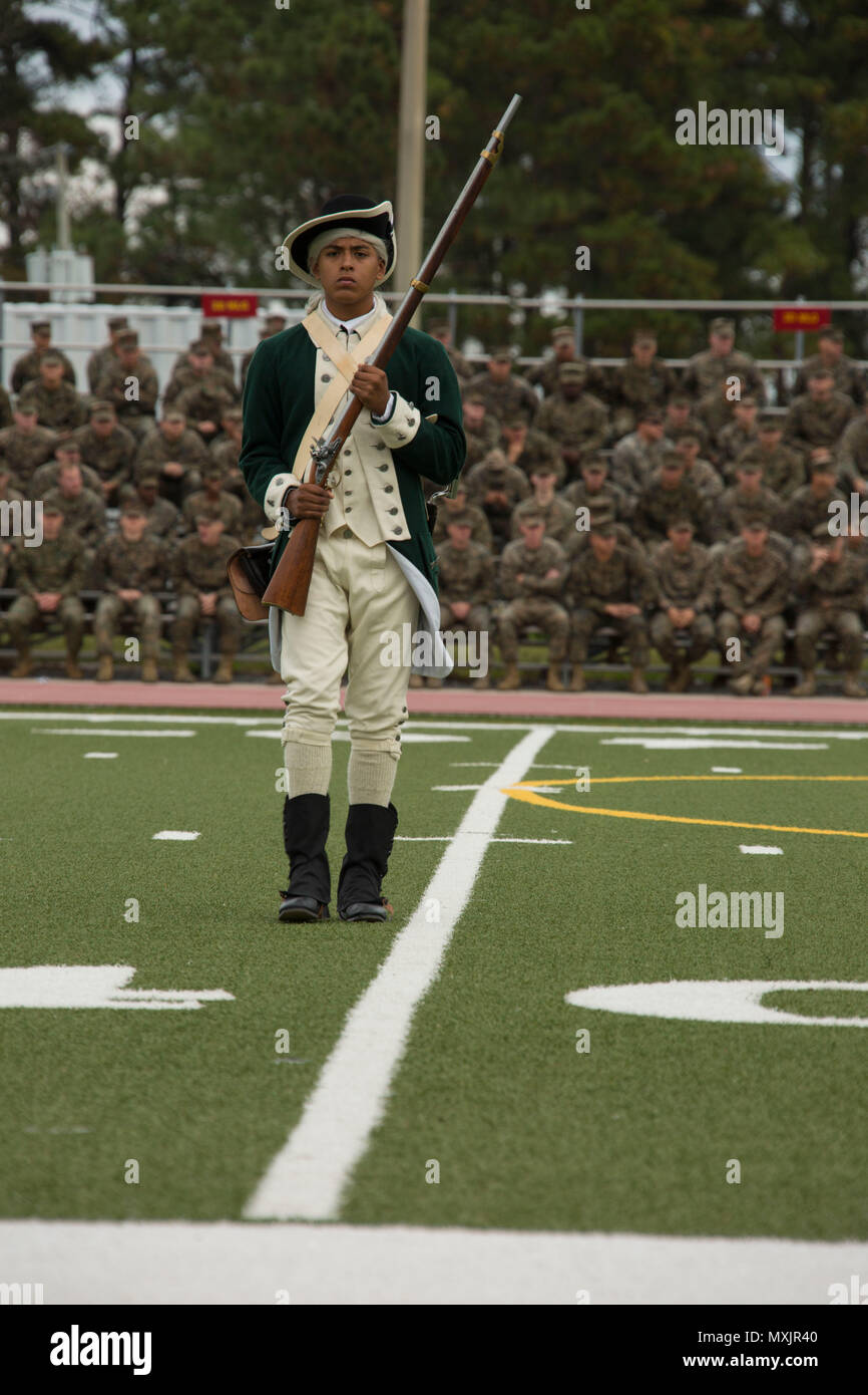 A U.S. Marine with the ceremonial pageant stands at port arms during ...