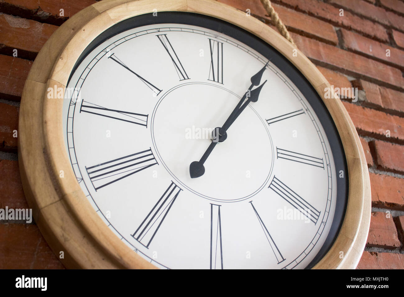 Old fashioned wall clock with roman numerals hi-res stock photography ...