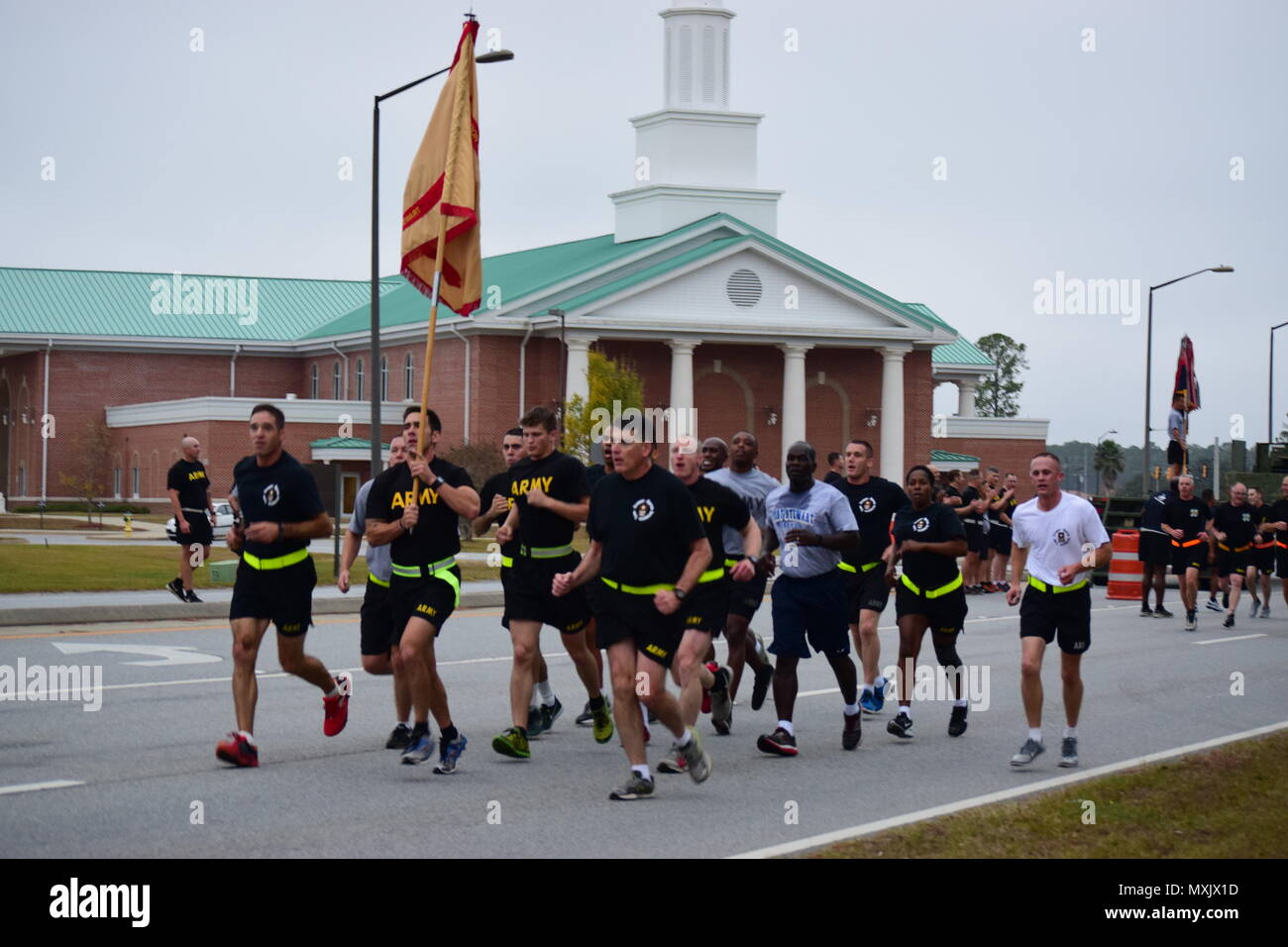 Marne Soldier holds the Garrison colors high during the four-mile run ...