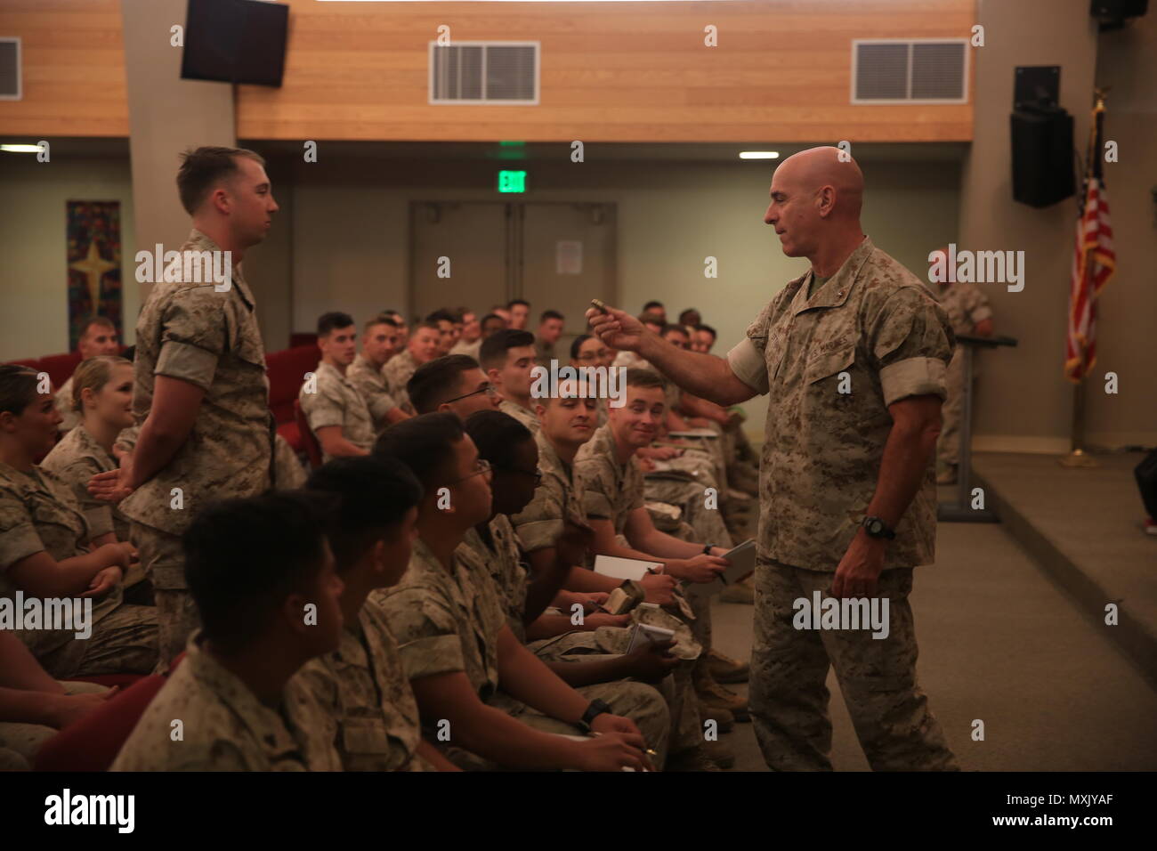 U.S. Marine Sgt. Brandon St. Clair, a career planner, receives a coin ...