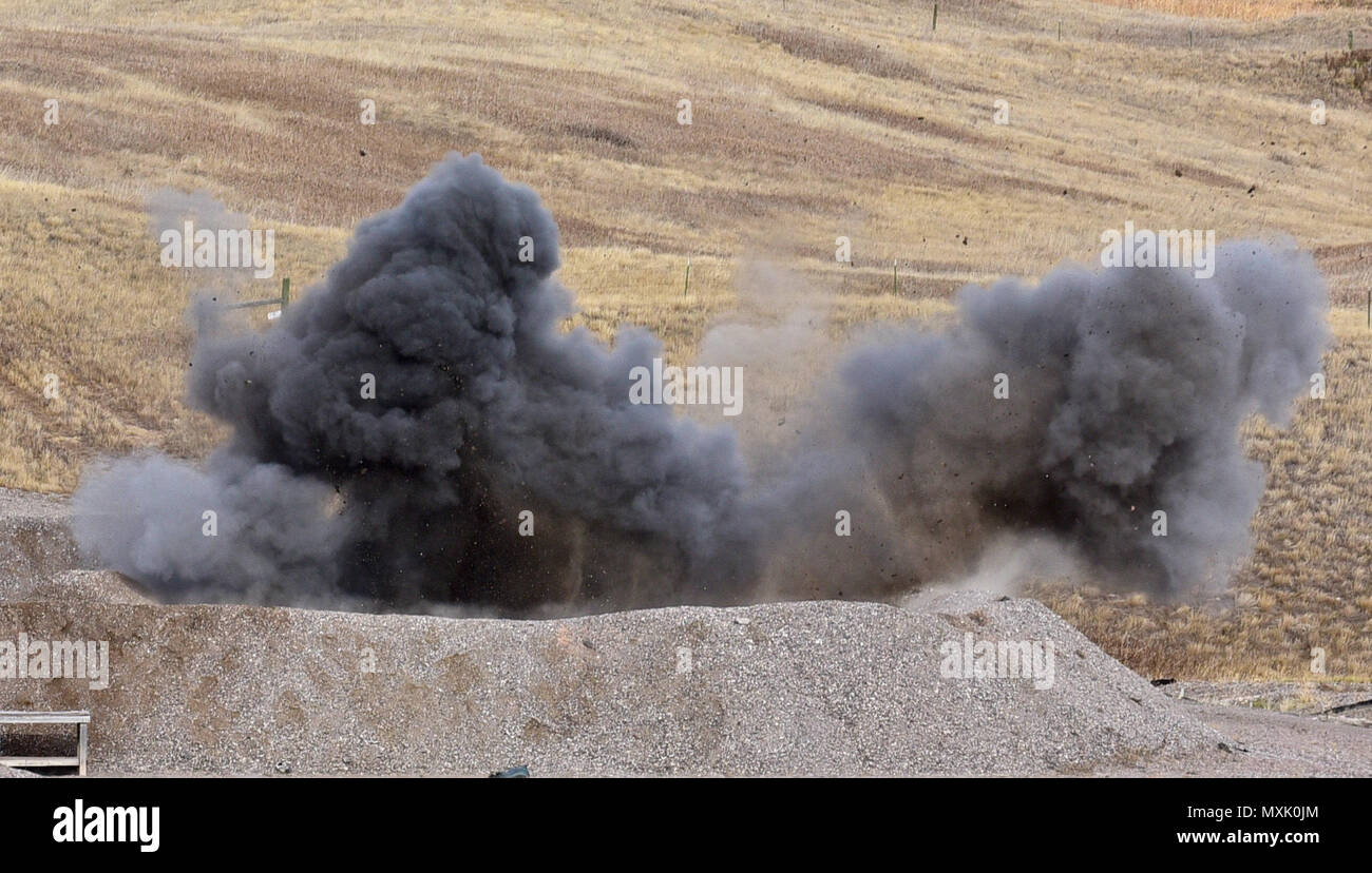 A controlled explosive ordnance disposal creates a cloud of smoke at ...