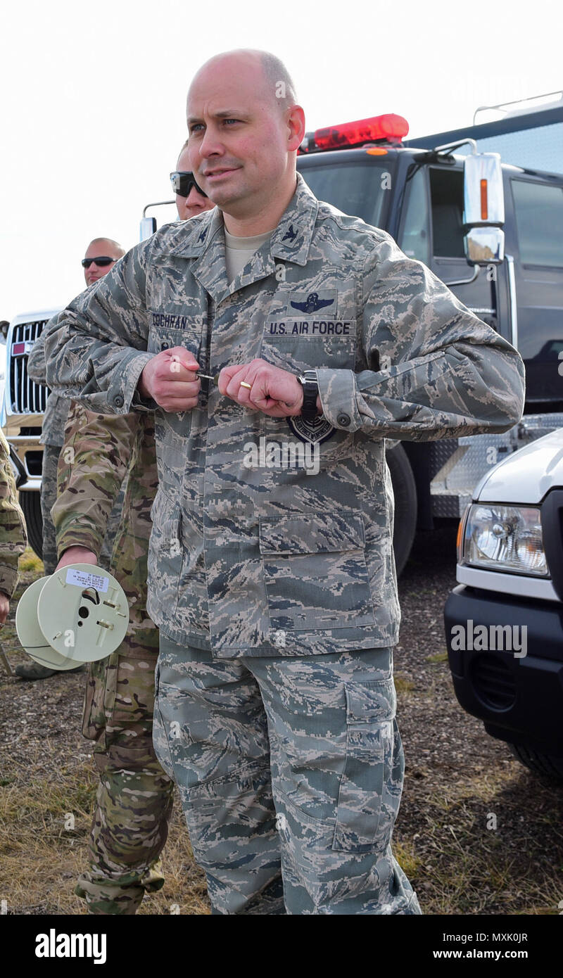 Col. Bradley Cochran, vice commander of the 28th Bomb Wing, pulls a pin ...