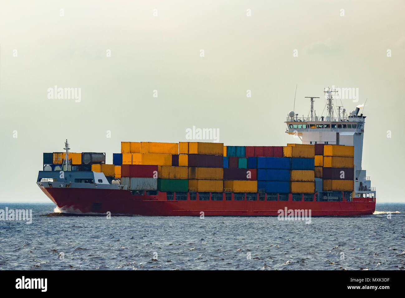 Red container ship. Logistics and production transfer Stock Photo - Alamy