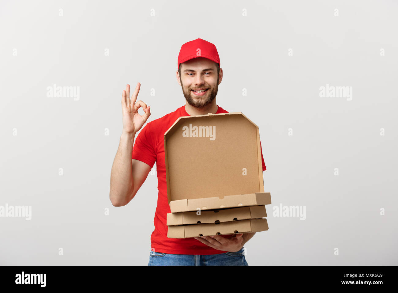 Delivery Concept: Handsome pizza delivery man making OK sign isolated ...