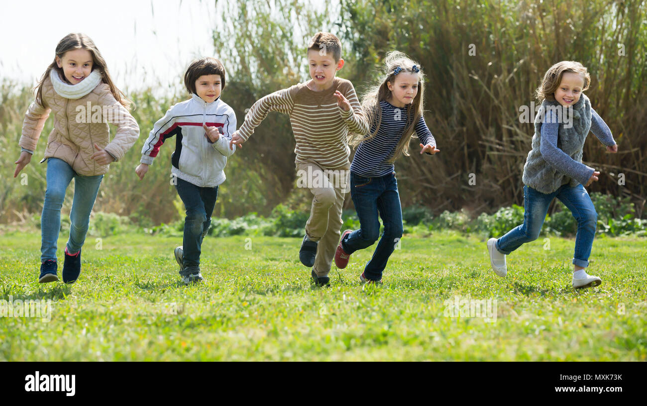 Group of happy kids running in race and laughing outdoors Stock Photo ...