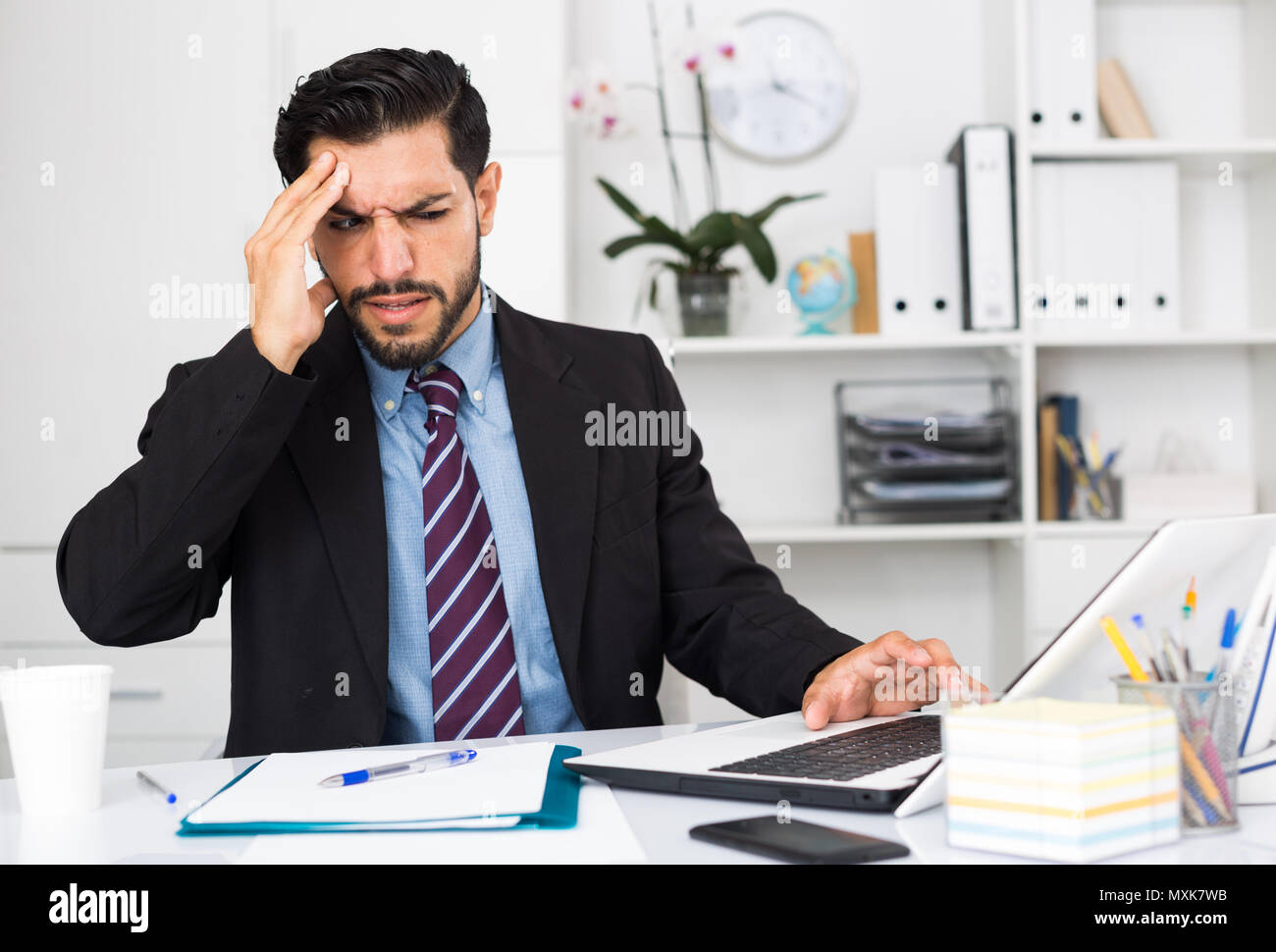 Spanish male worker is having complicated issue with project in office ...