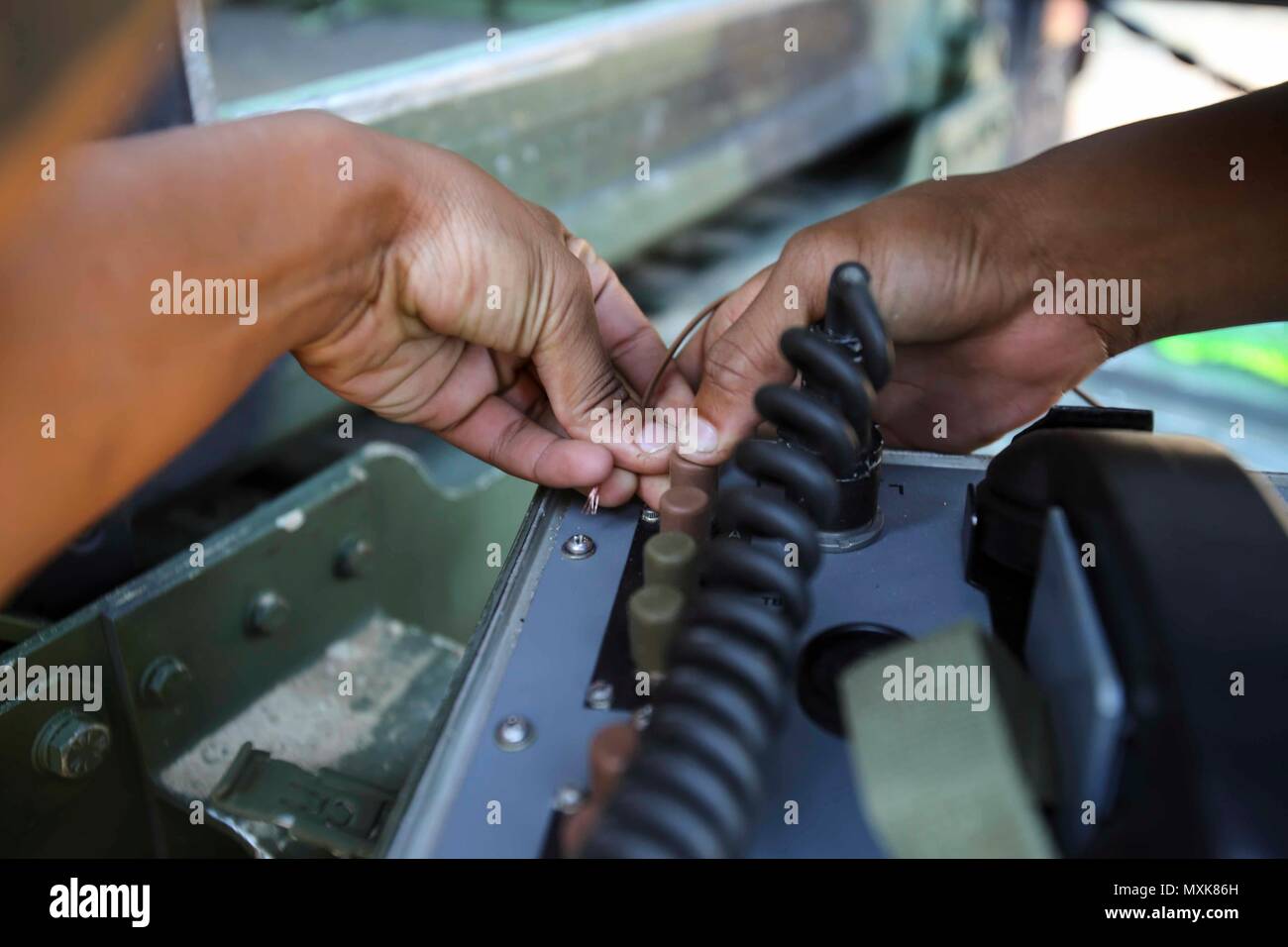 Corporal Leonard Richburg attaches slash wire to a remote control unit ...