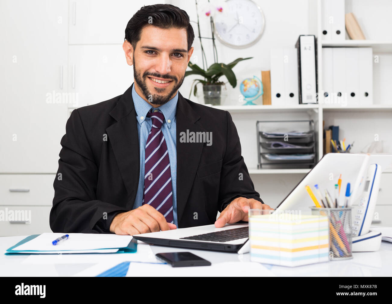 Spanish man is having a productive day at work in office Stock Photo ...