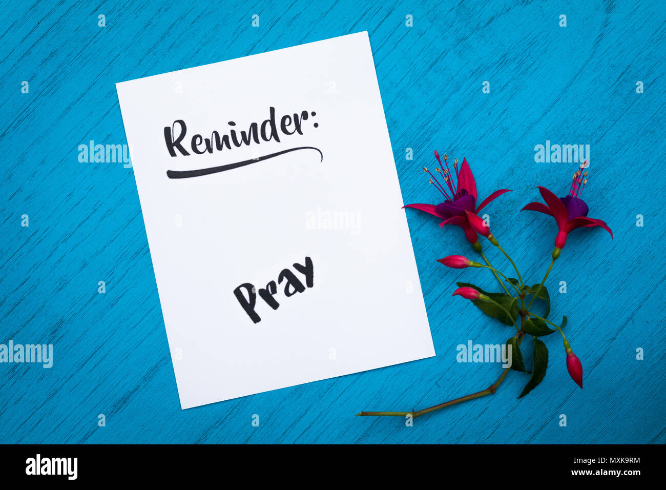 Reminder to Pray still life motivational concept on white paper and ...