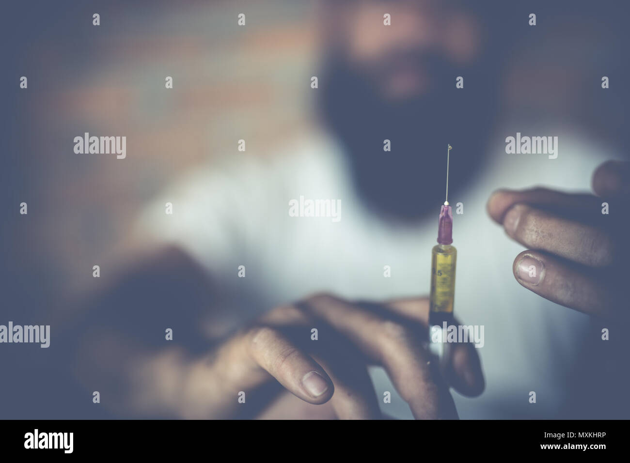 Drug addict man with syringe using drugs, Drugs concept Stock Photo - Alamy