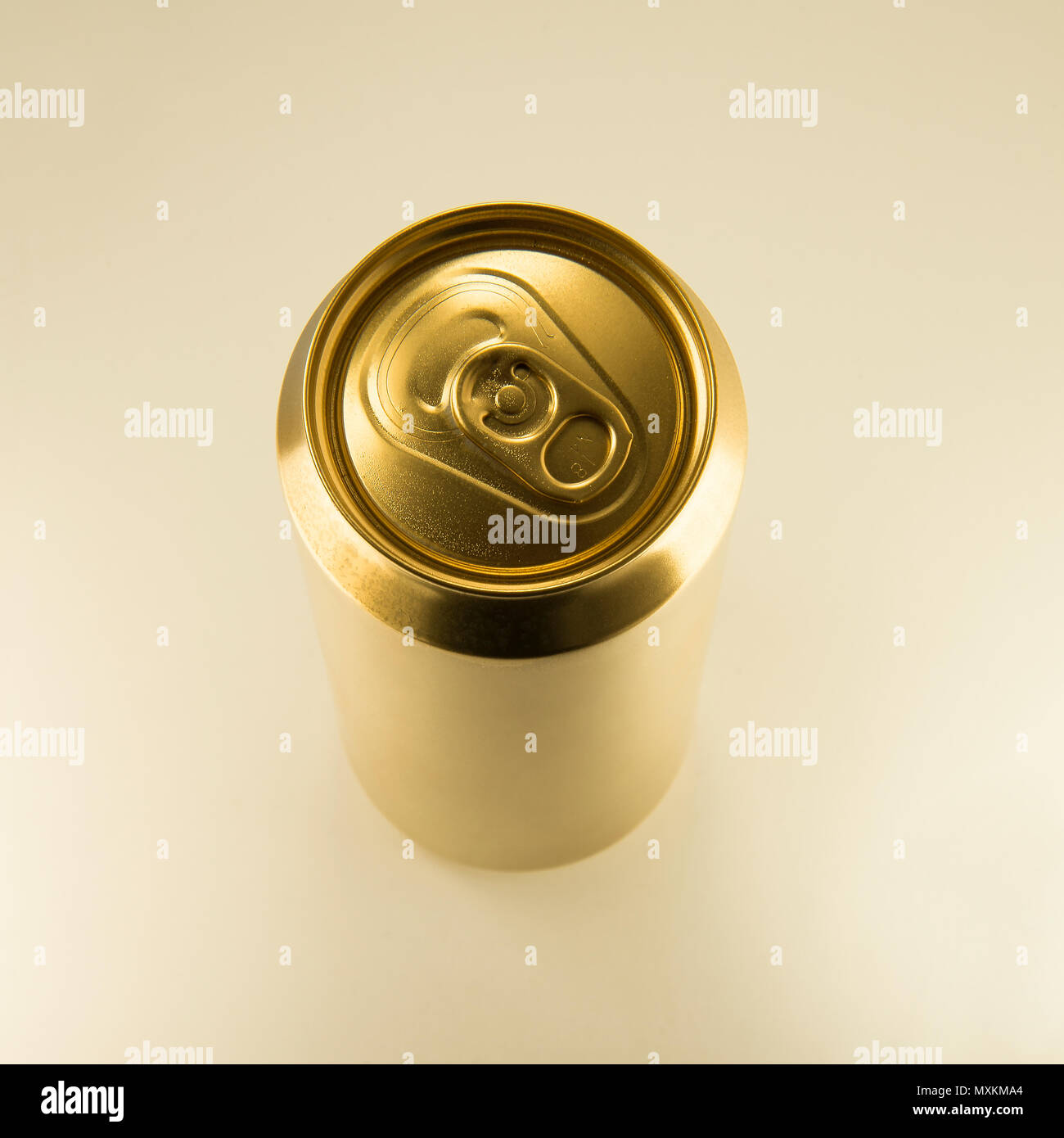 Gold can on white background Stock Photo - Alamy