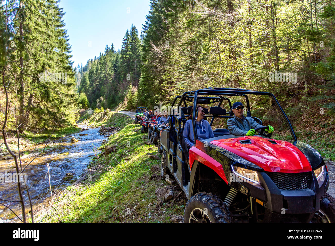 A tour group travels on ATVs and UTVs on the mountains Stock Photo - Alamy