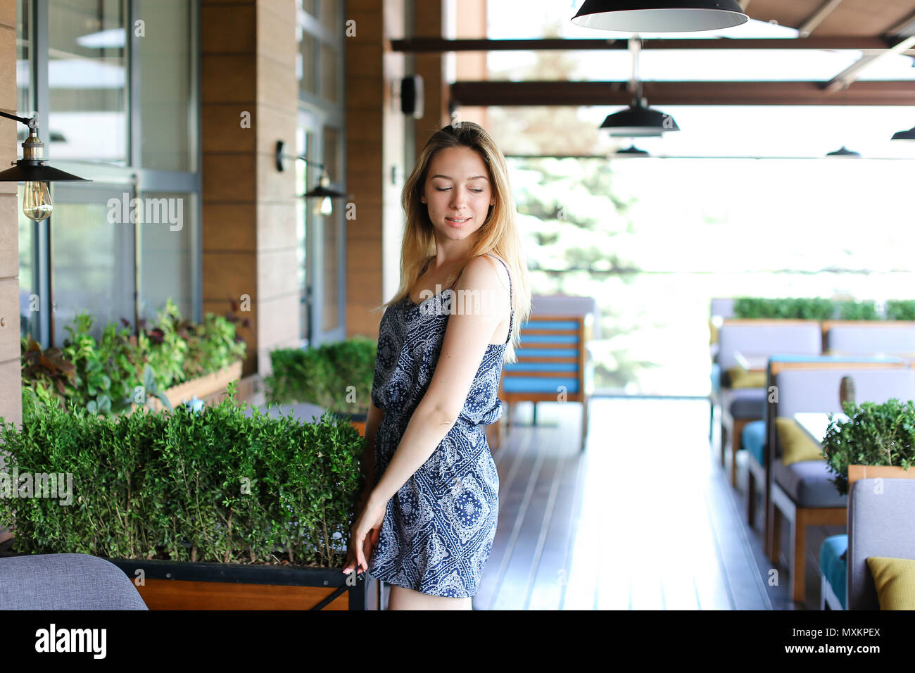 Girl standing cafe near hi-res stock photography and images - Alamy
