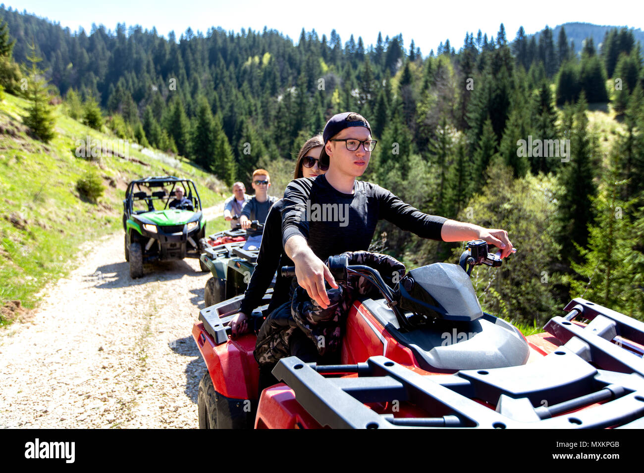A tour group travels on ATVs and UTVs on the mountains Stock Photo - Alamy