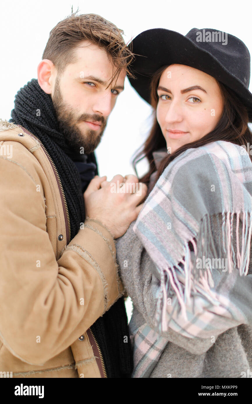 Portrait of european couple wearing scarf and hat in white background ...