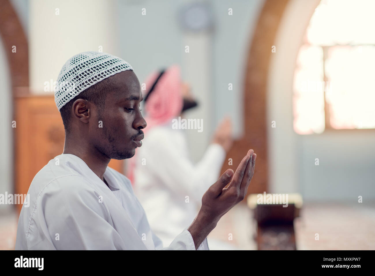Two religious muslim man praying together inside the mosque Stock Photo ...