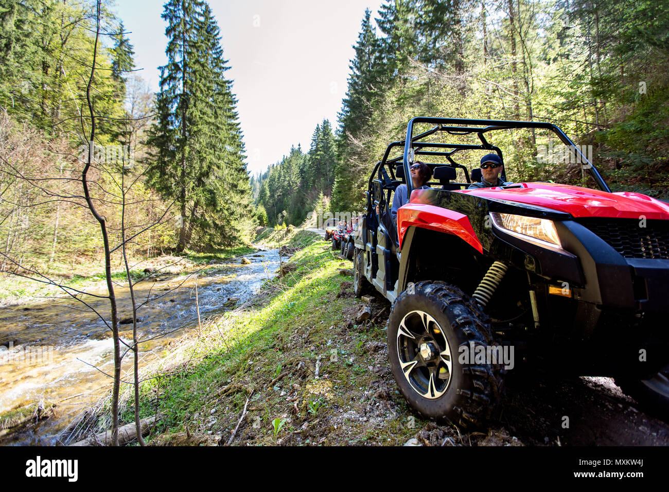 A tour group travels on ATVs and UTVs on the mountains Stock Photo - Alamy